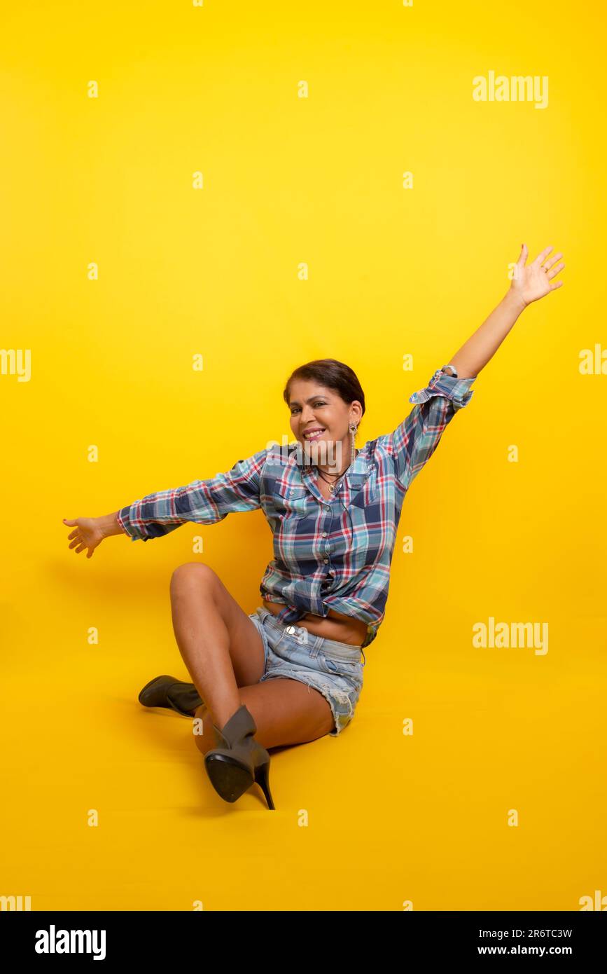 Beautiful mature woman sitting on the floor, dressed in June costume ...