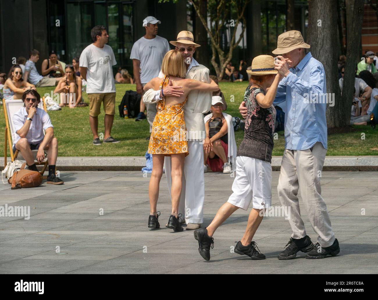 People take part in free Tango dance lessons during the hot weather, at ...