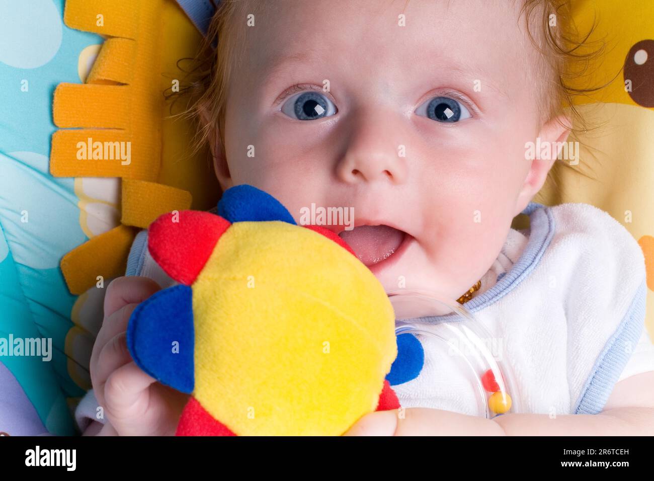 Baby with colourful background smiles happily Stock Photo - Alamy