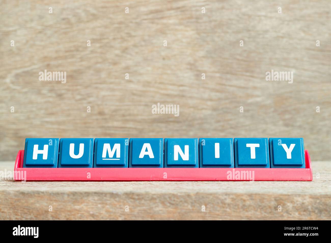Tile alphabet letter with word humanity in red color rack on wood ...