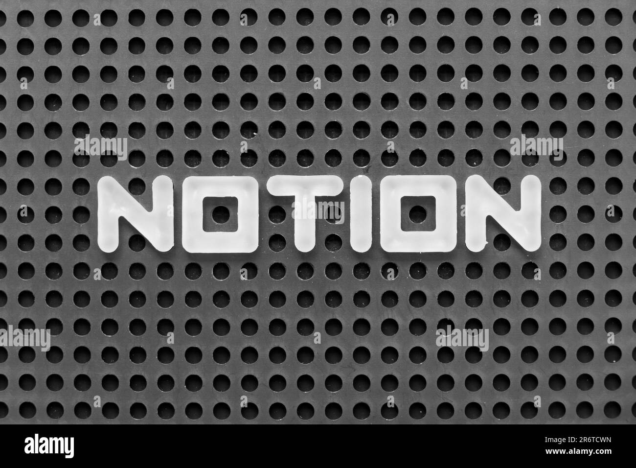 White alphabet letter in word notion on black pegboard background Stock ...