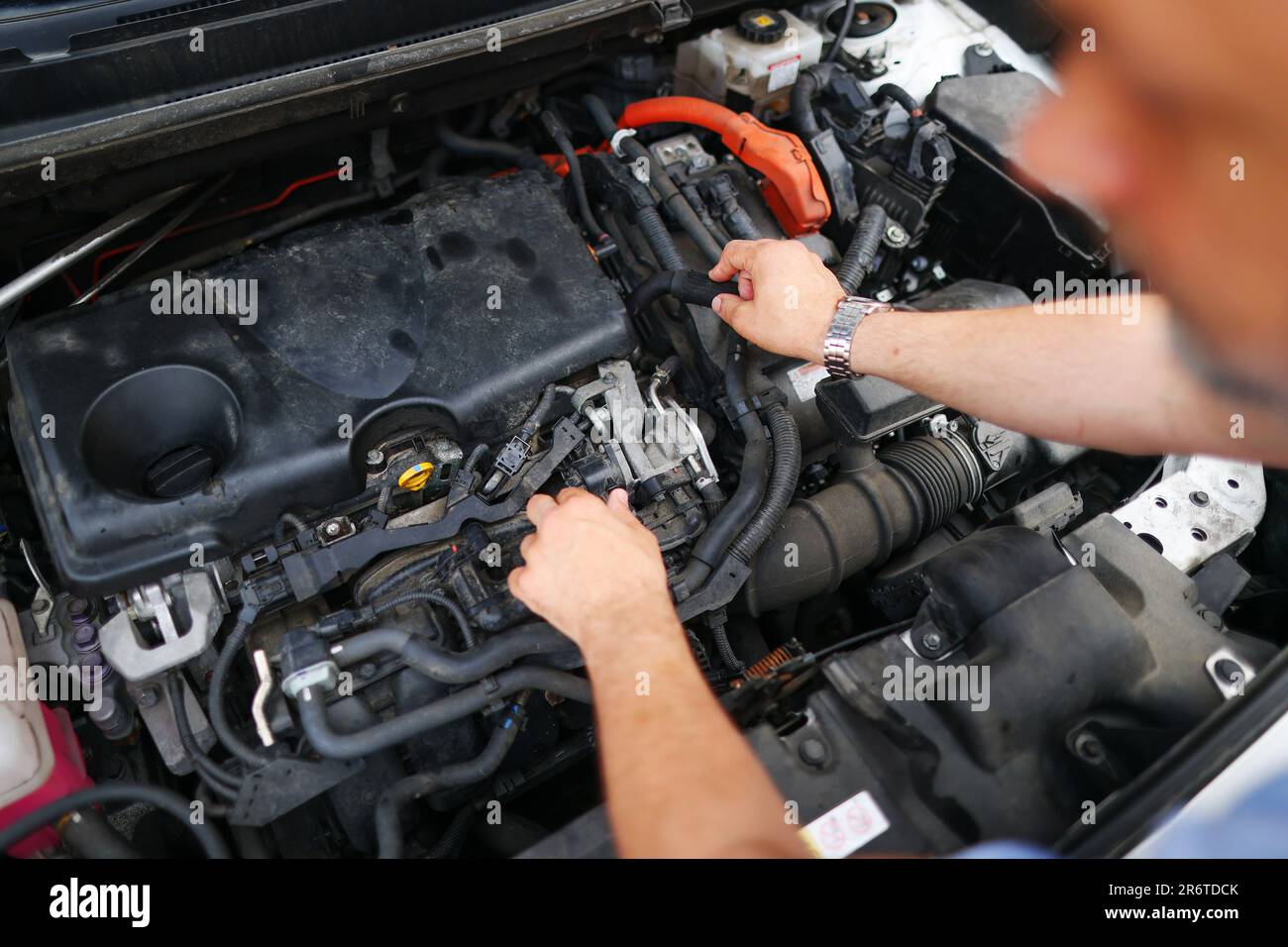 male mechanics hands check electrical wiring vehicle system in a car ...