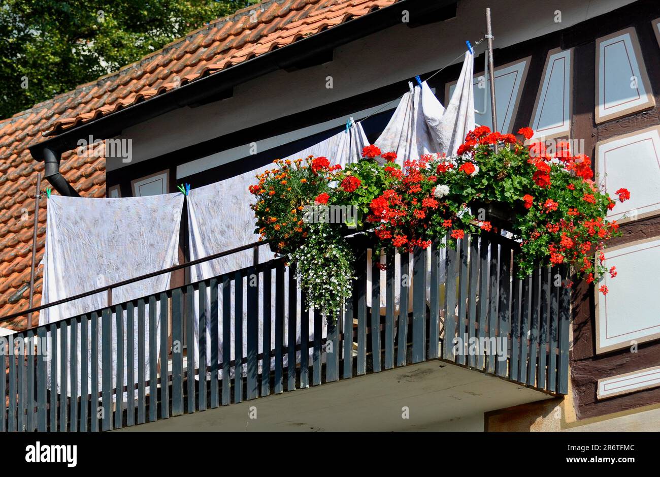 Laundry hung up, washing day with bed linen on balcony to dry with ...