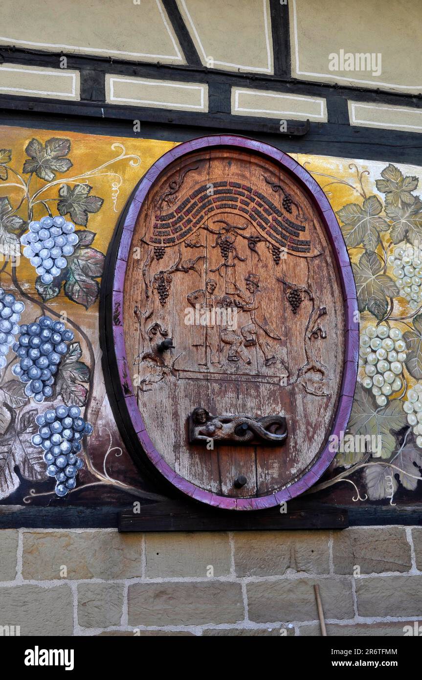 Wine barrel in house wall, with grape stems Stock Photo - Alamy