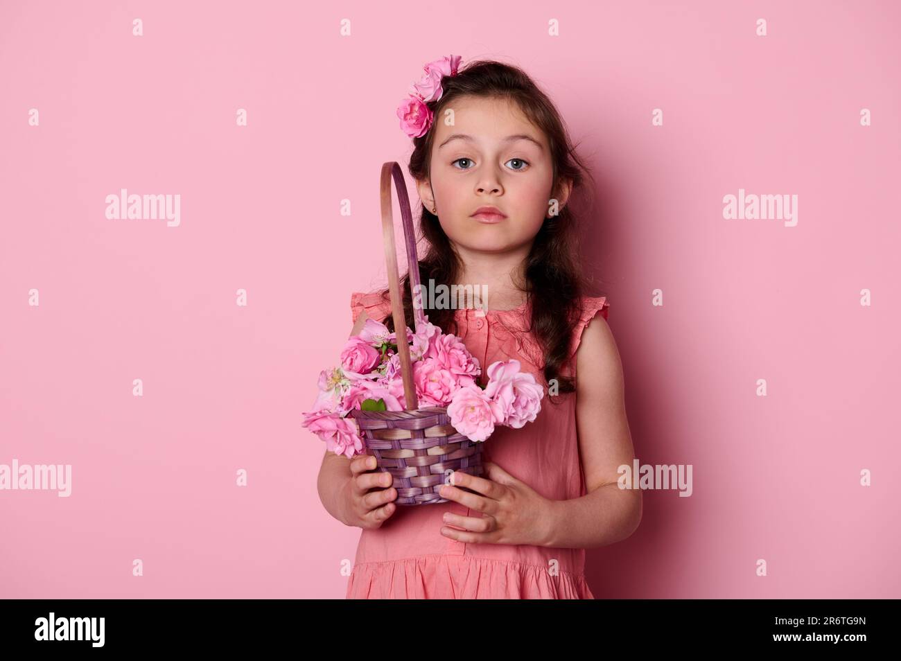 Noble little girl with curly hair and beautiful blue eyes, holding ...