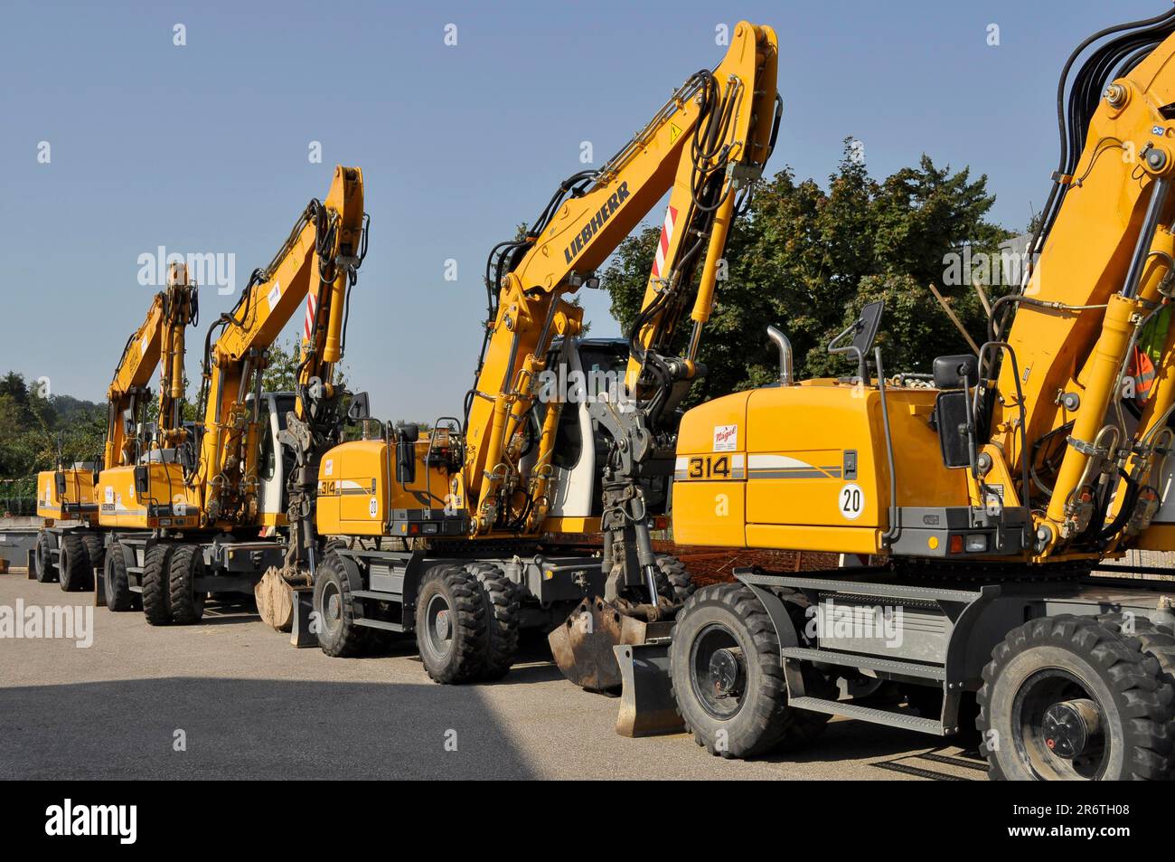 Four excavators out of work, excavator in rest position Stock Photo - Alamy