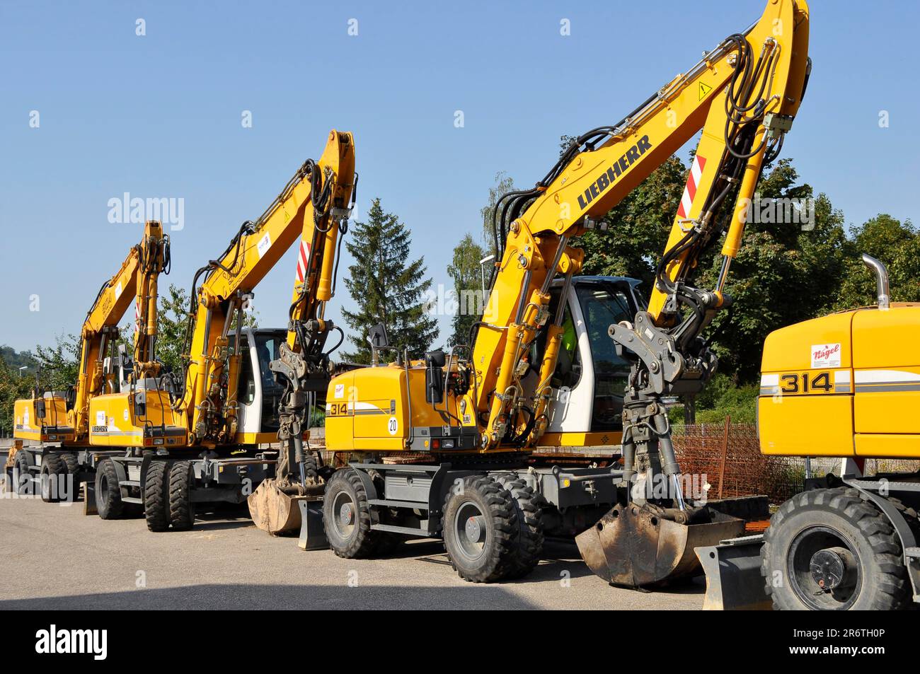 Four excavators out of work, excavator in rest position Stock Photo - Alamy