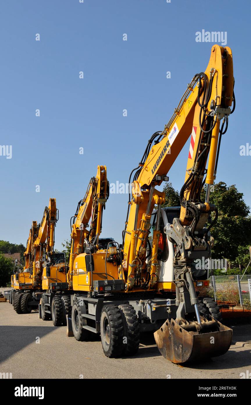 Four excavators out of work, excavator in rest position Stock Photo - Alamy