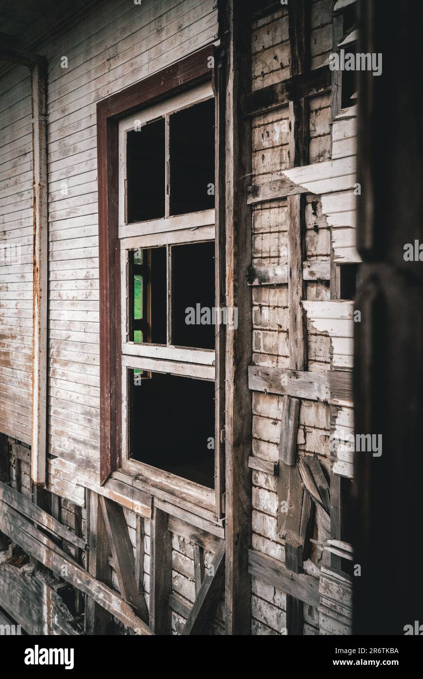 Time-worn wooden window in a weathered, ancient house. Layers of ...