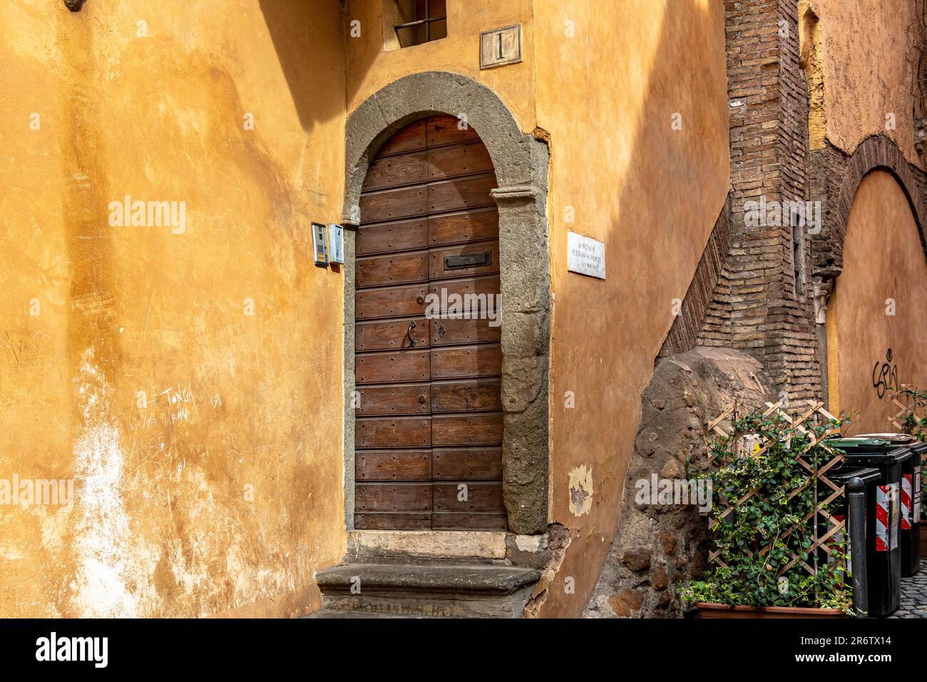 A large wooden door in a building on Vicolo della Luce in Trastevere ...