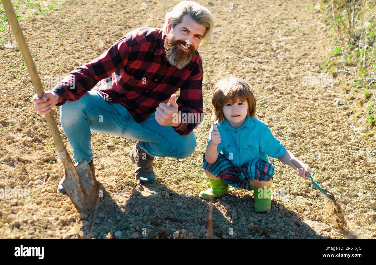 Family planting a tree like. Father helping son. Dad and kid gardening ...