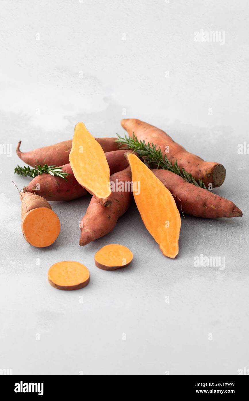 Raw sweet potatoes whole and cut. Orange kumara, sweet potato ...