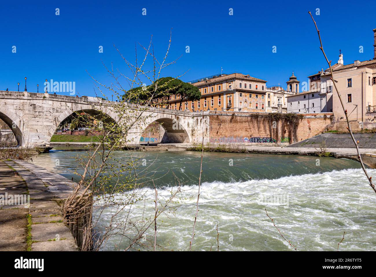 The Ponte Cestio bridge spanning The River Tiber with Tiber Island in ...