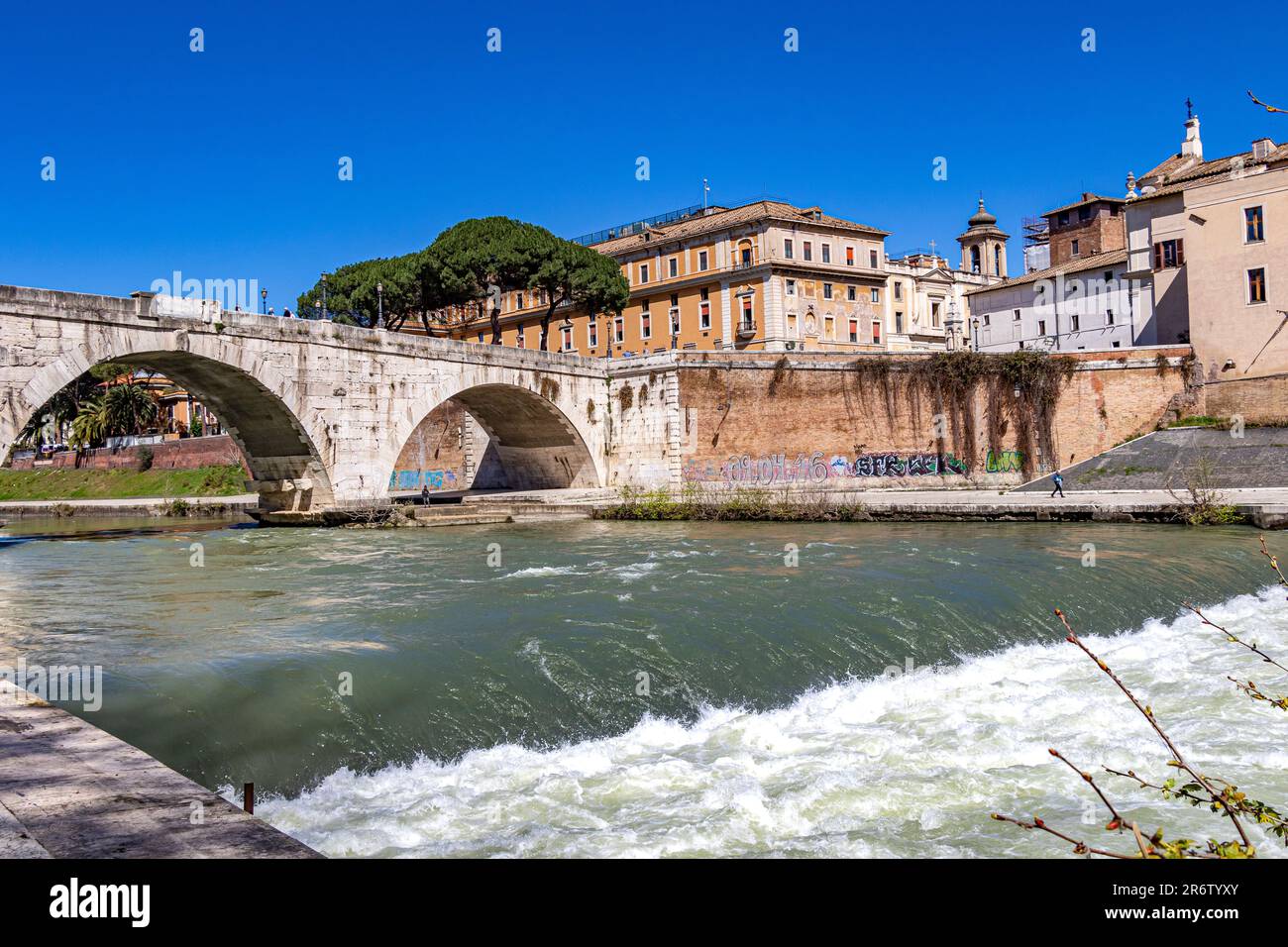 The Ponte Cestio bridge spanning The River Tiber with Tiber Island in ...