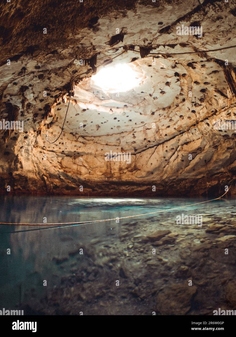 An abandoned closed cenote resembles a mystical cave, its hidden depths ...