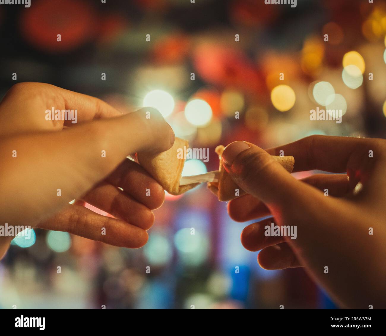 Hands holding a Chinese cookie: A moment of anticipation and curiosity ...