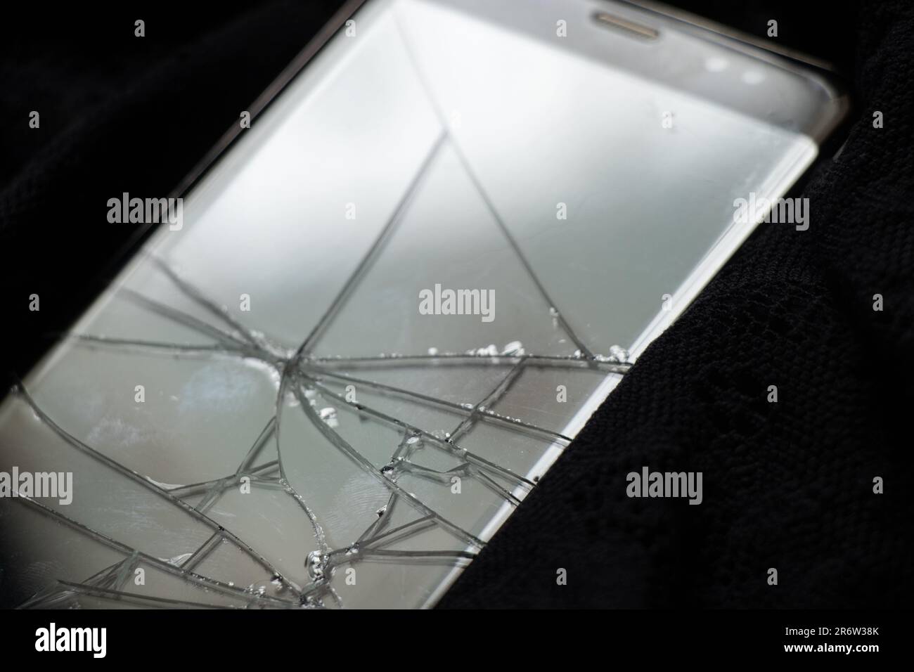 cracked phone screen on black background, broken phone Stock Photo - Alamy