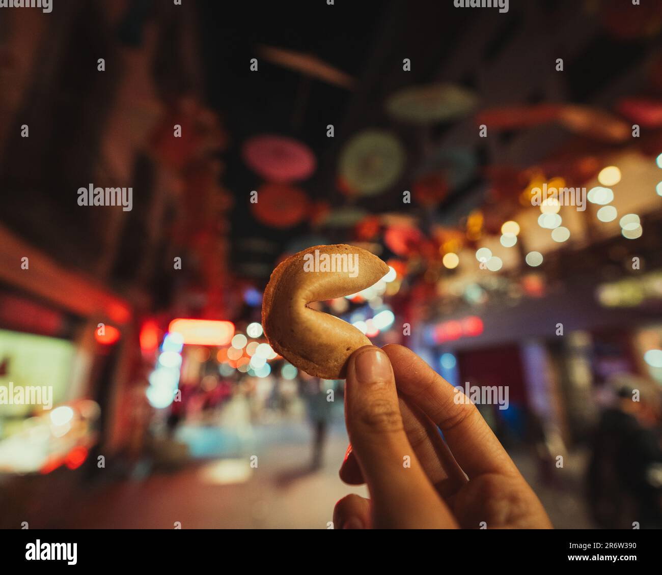 Hands holding a Chinese cookie: A moment of anticipation and curiosity ...