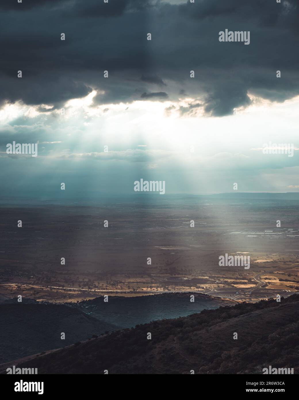 A breathtaking landscape unfolds as billowing clouds part, allowing sun ...