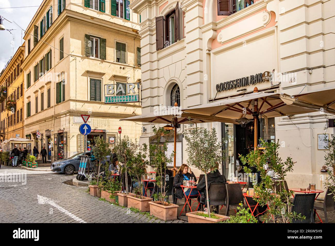 People sitting outside The Colosseum Bar in Monti ,a fashionable ...