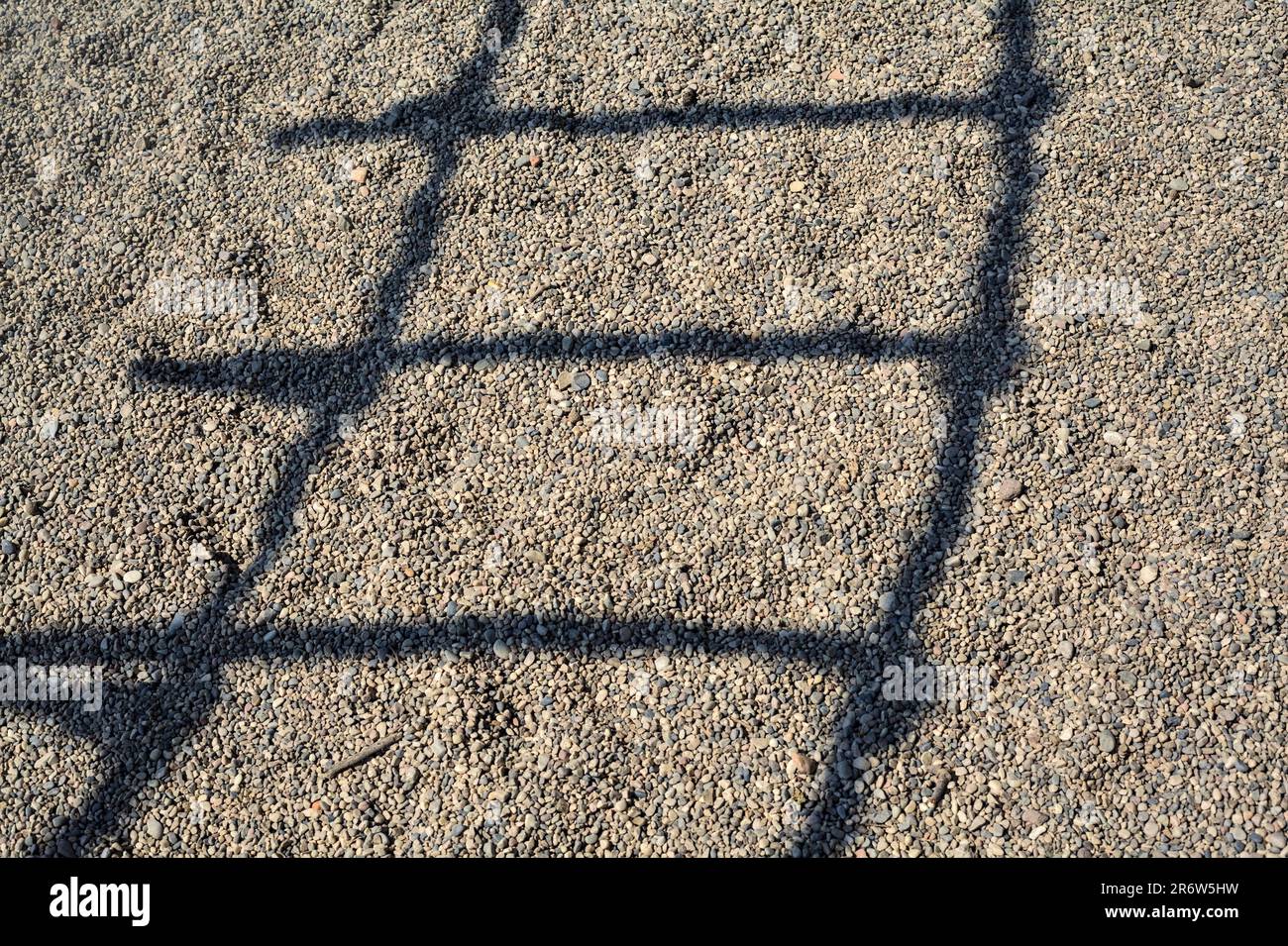 Shadow of a ladder casted on pebbles Stock Photo - Alamy