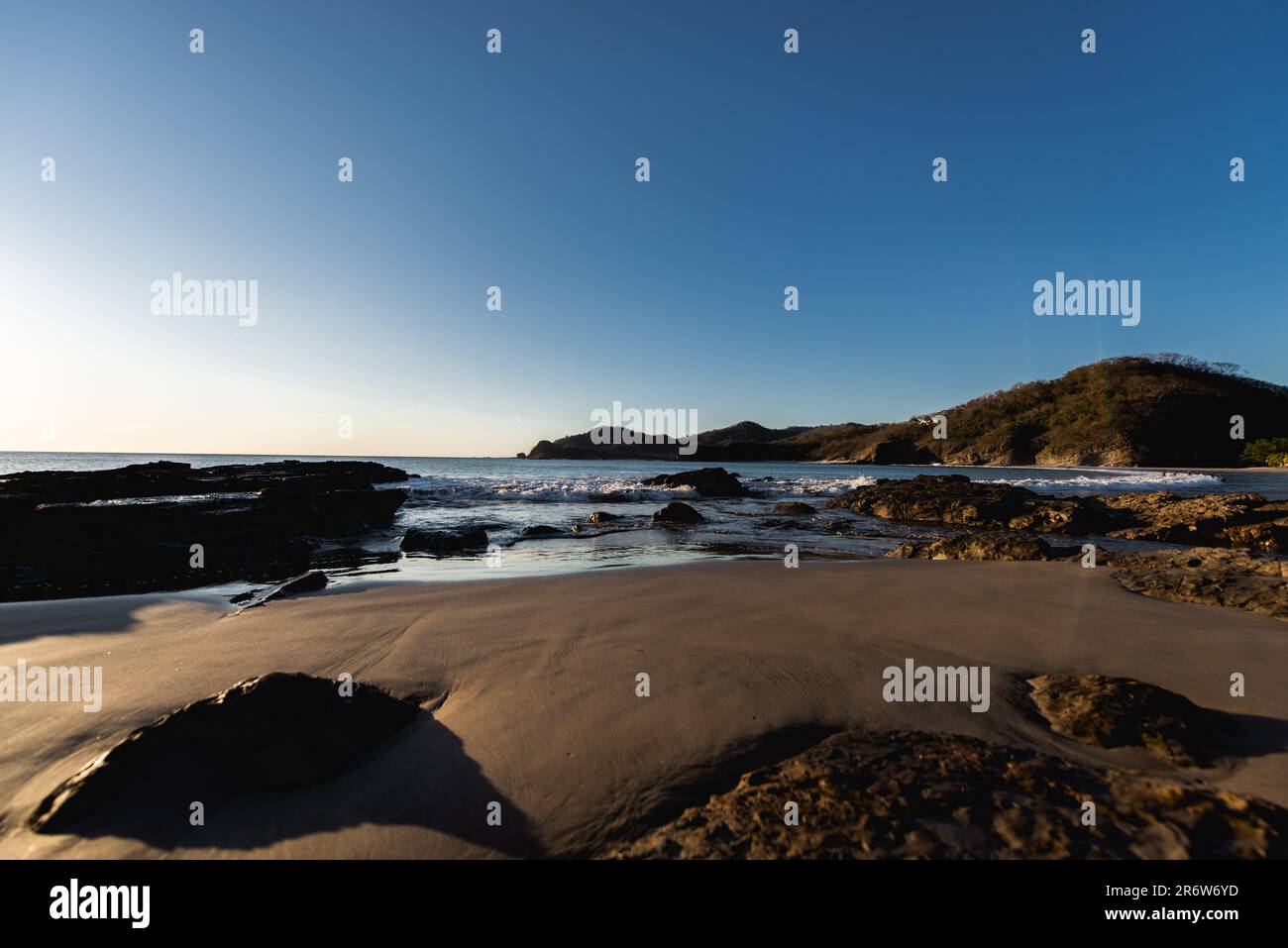 Sunset landscape photo with clear sky overlooking the sandy beach ...