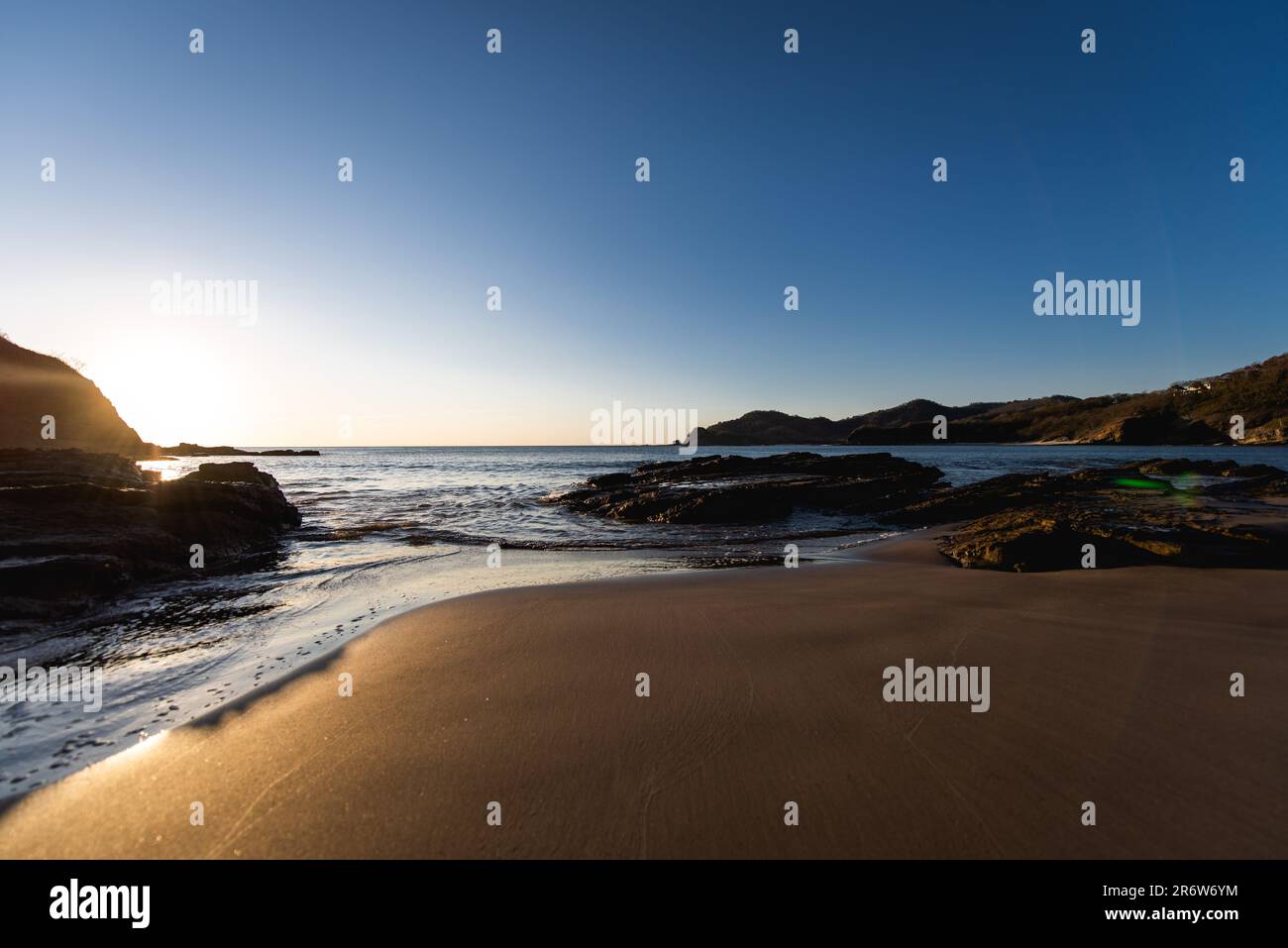Sunset landscape photo with clear sky overlooking the sandy beach ...