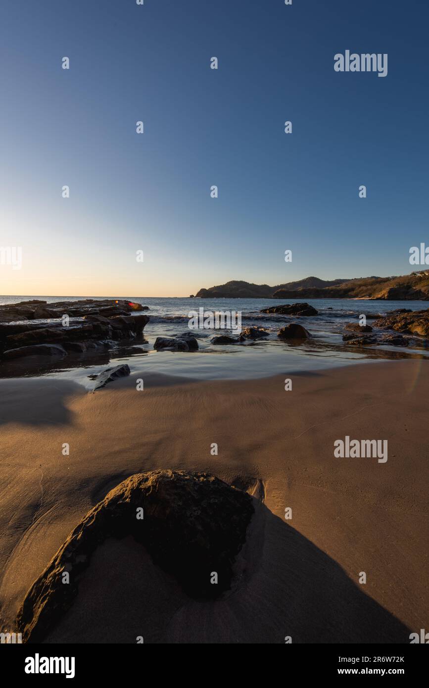 Sunset landscape photo with clear sky overlooking the sandy beach ...