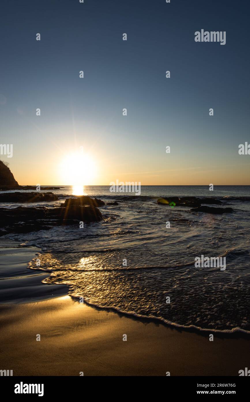 Sunset landscape photo with clear sky overlooking the sandy beach ...