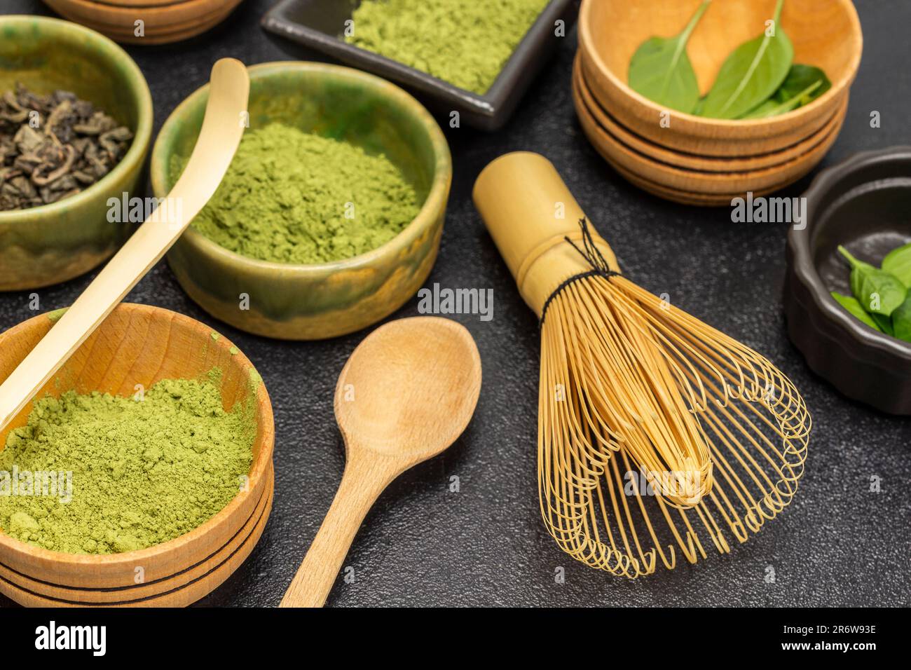 Bamboo whisk and measuring spoon. Matcha green tea powder in bowl ...