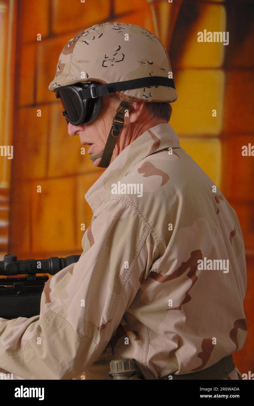 Camouflaged older soldier with sniper rifle inside building Stock Photo ...