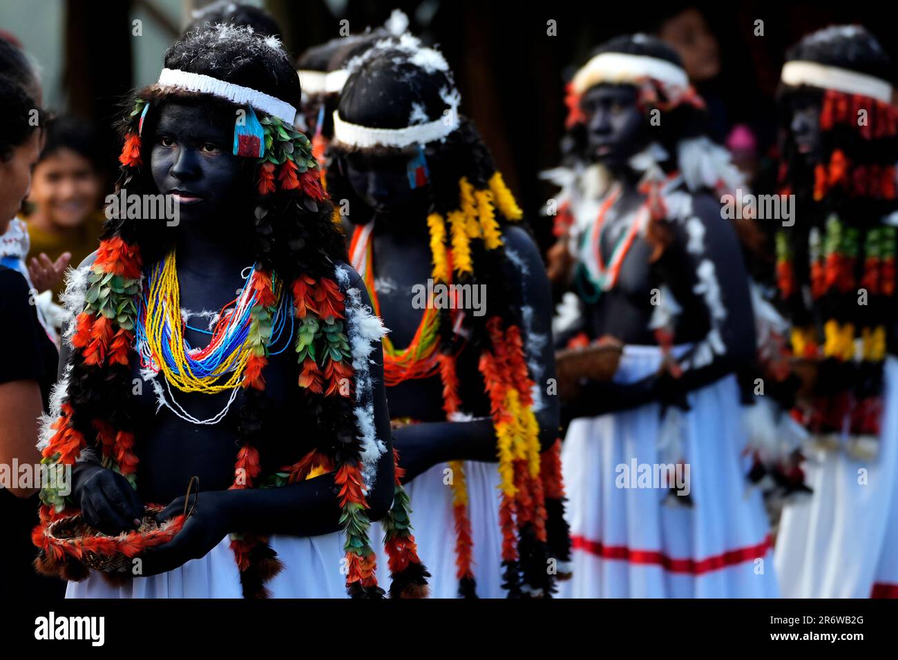 Indigenous girls distribute Moqueado, ritual food made with game meat ...