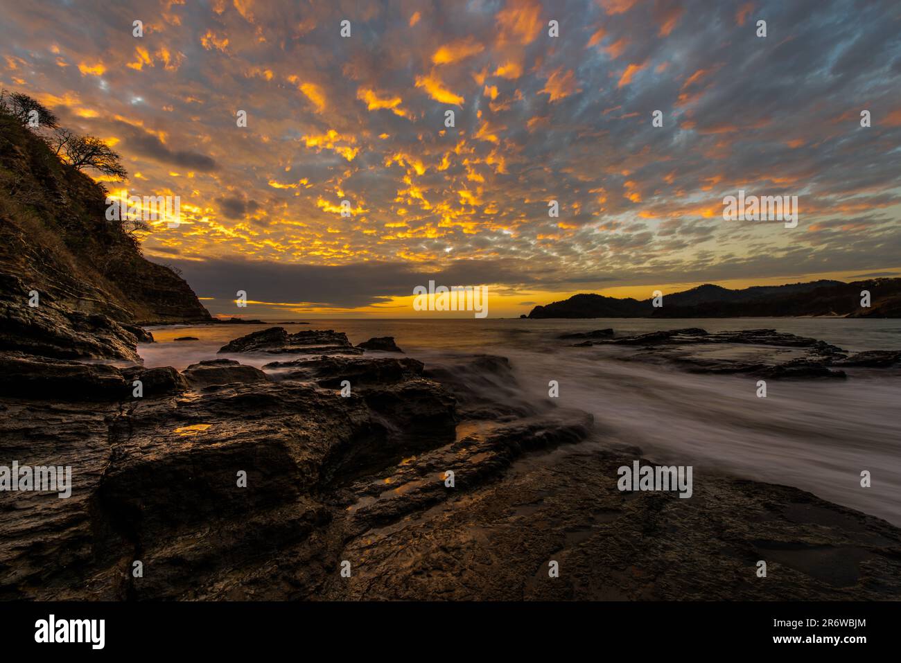 Long exposure landscape photo of pacific ocean water flowing over rocks ...