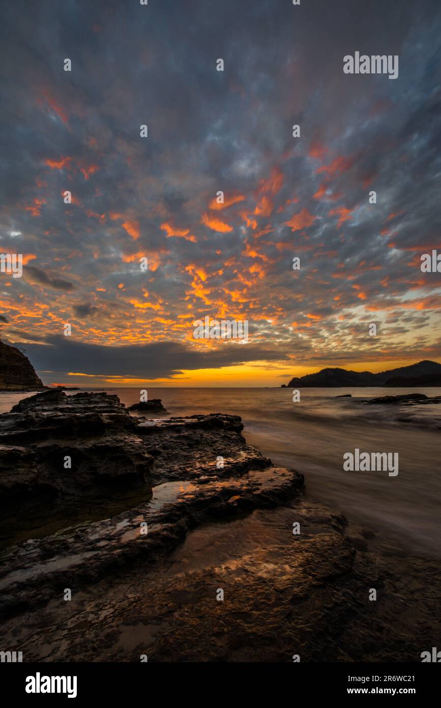 Long exposure landscape photo of pacific ocean water flowing over rocks ...