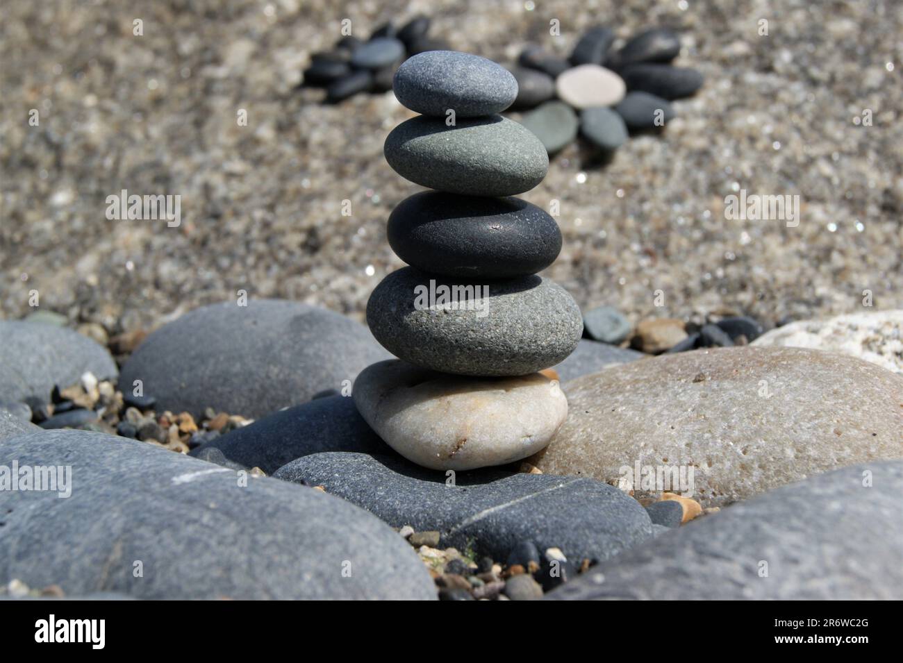 Zen pyramid on rocks. The subject is in focus, the background is ...
