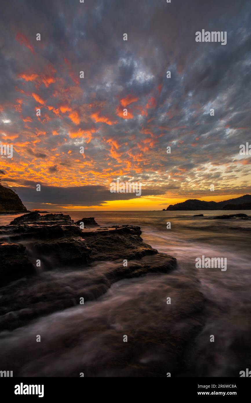 Long exposure landscape photo of pacific ocean water flowing over rocks ...