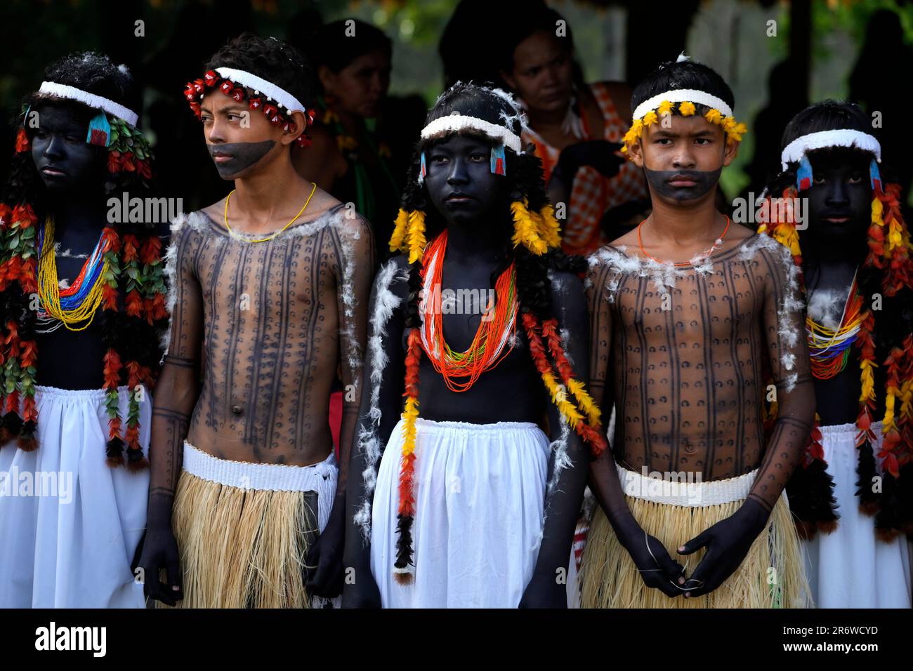 Indigenous girls and boys prepare to take part in a dance during the ...