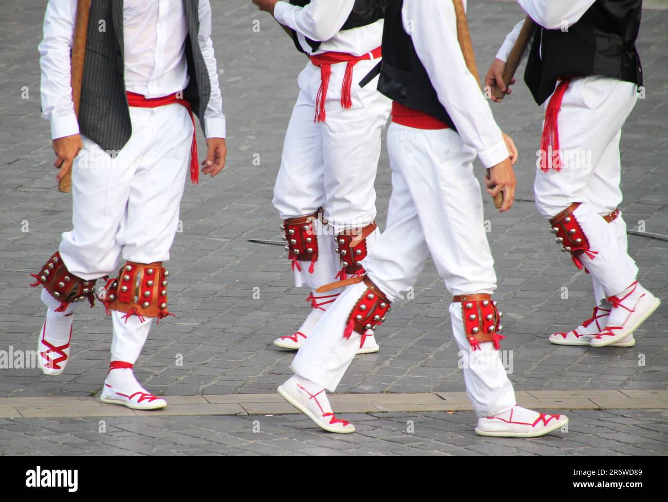 A group of cheerful and diverse young men dressed in festive costumes ...