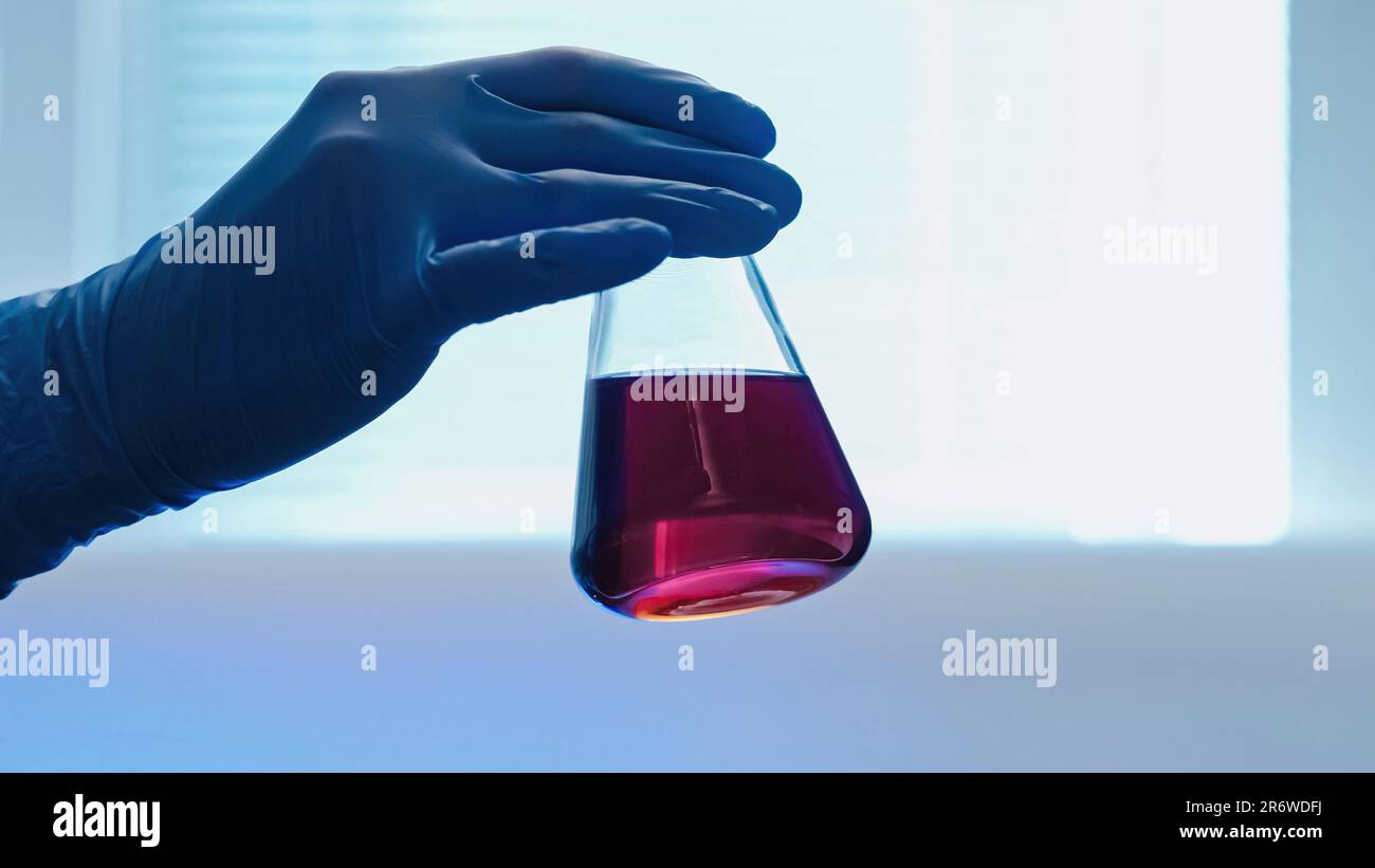 Chemical laboratory test technician hand flask Stock Photo - Alamy