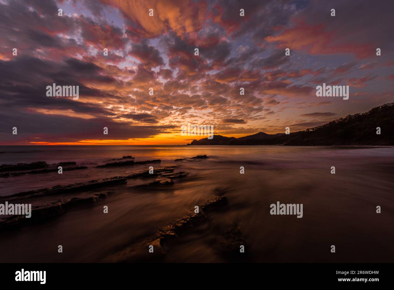 Long exposure landscape photo of pacific ocean water flowing over rocks ...