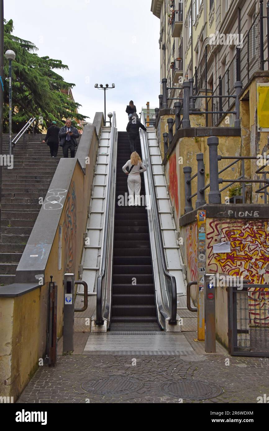 An outdoor public escalator next to steps in a street in Naples, Italy ...