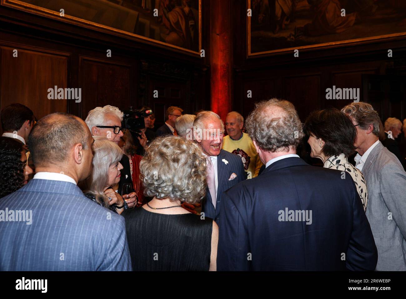 King Charles III (centre) laughs as he speaks with guests during a reception with authors ...