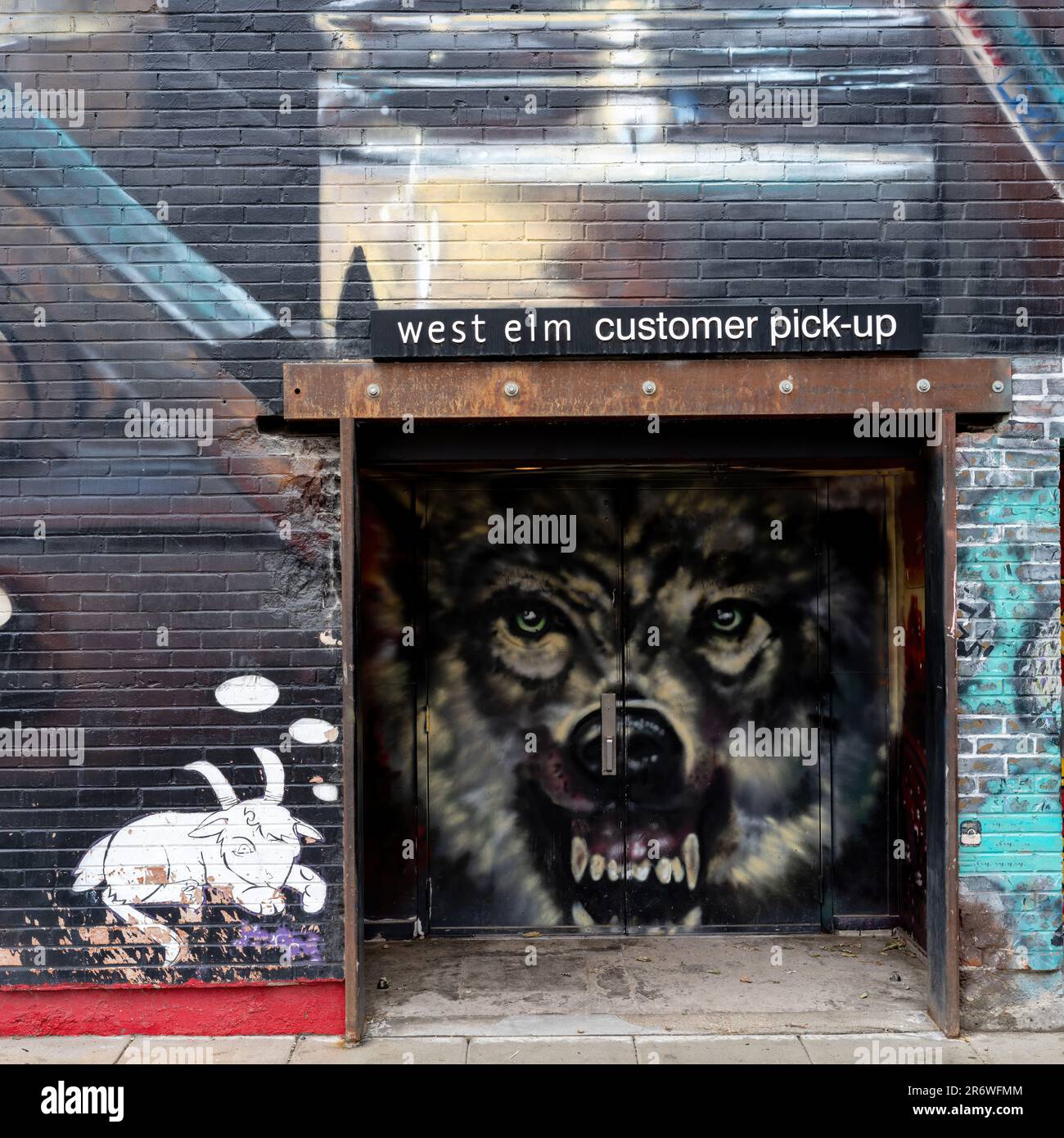 Wolf painted doors at a customer alley pickup location Stock Photo - Alamy