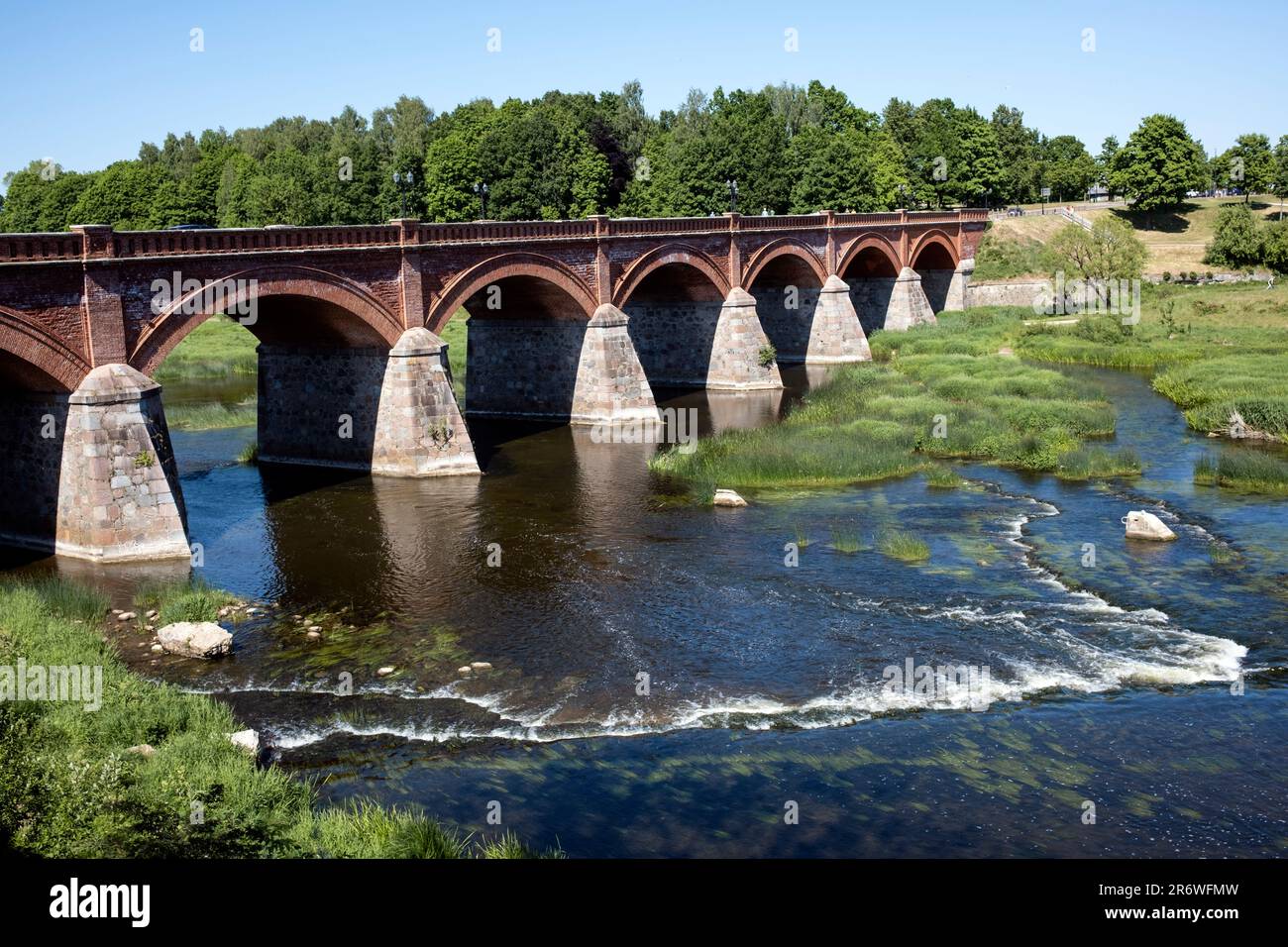 The old brick bridge across the Venta river in Kuldiga city, Latvia ...