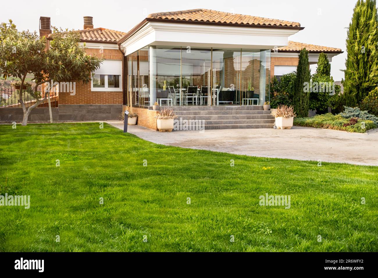 Private family house entry with porch and garden. Side view of the ...