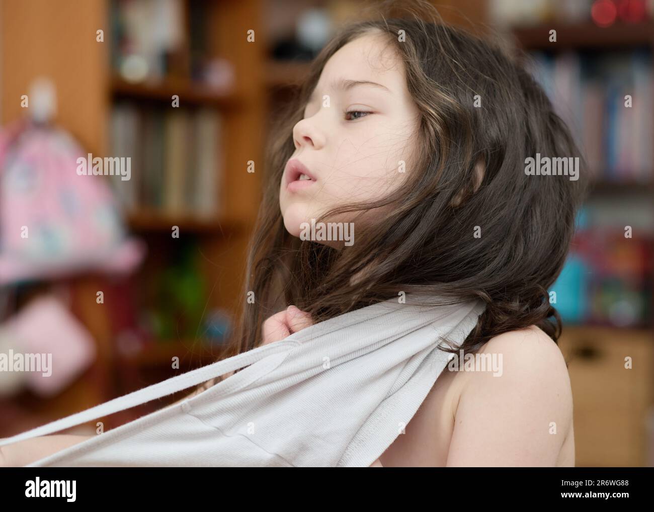 cute young girl getting dressed in her room Stock Photo - Alamy