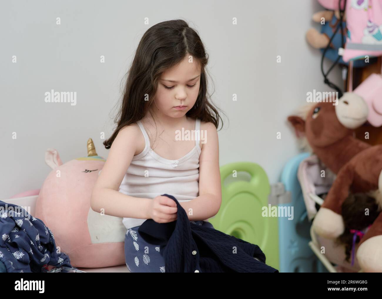 cute young girl getting dressed in her room Stock Photo - Alamy