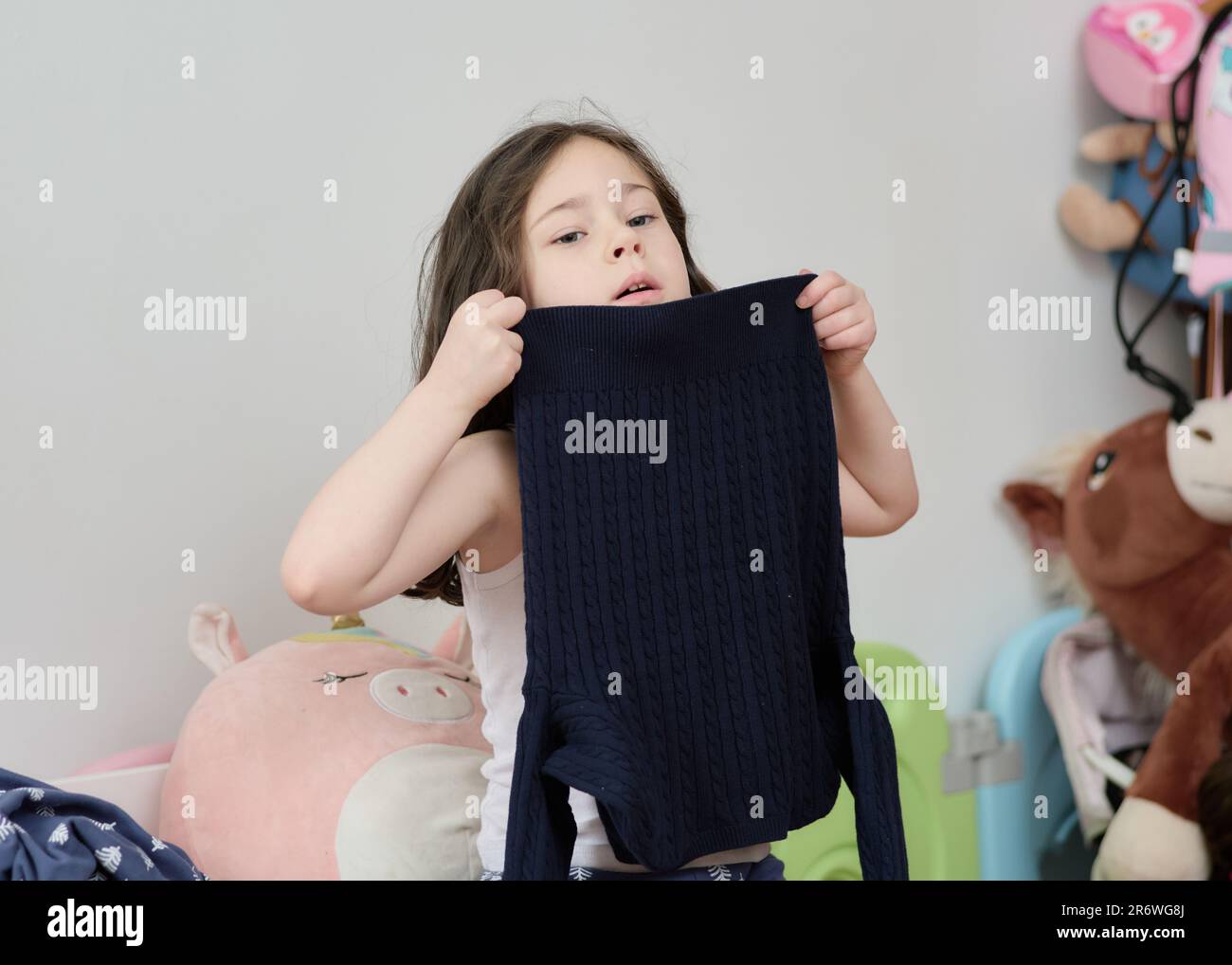 cute young girl getting dressed in her room Stock Photo - Alamy