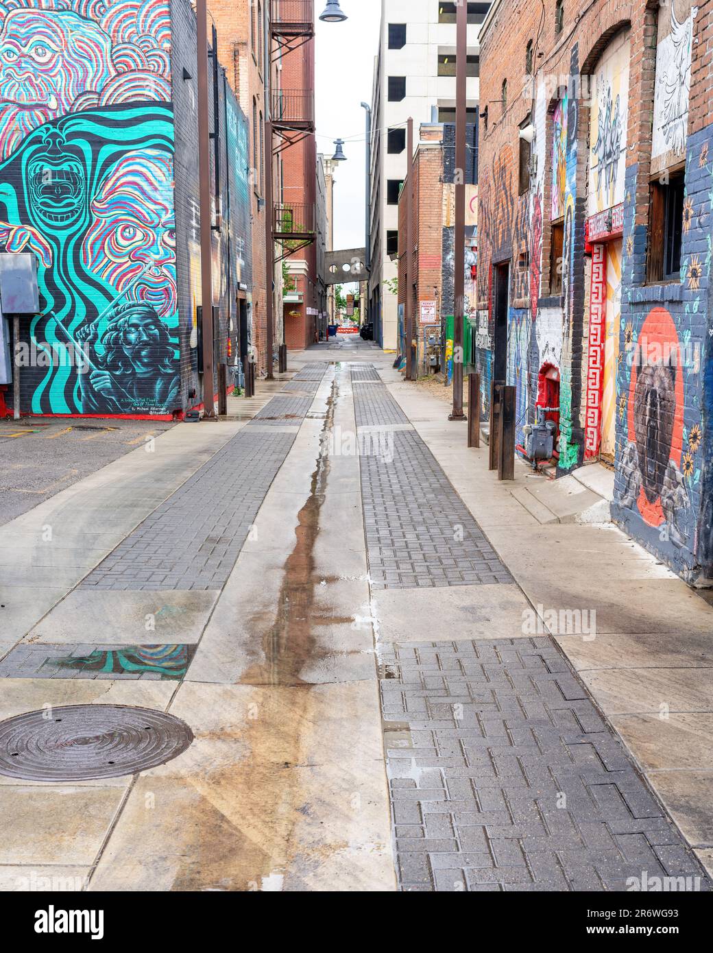 Rain drain with water in an urban alley in downtown Stock Photo - Alamy
