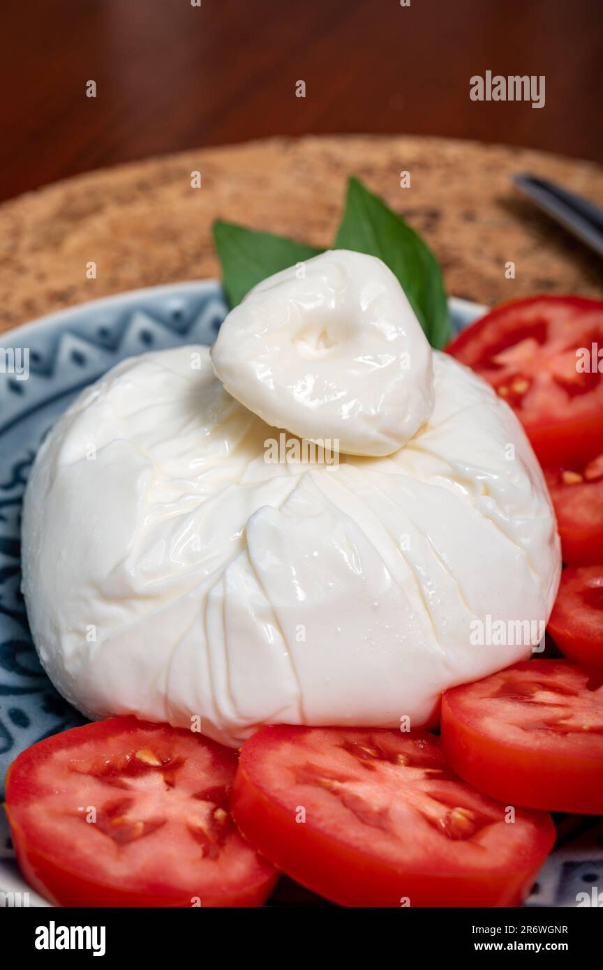Fresh handmade soft Italian cheese from Puglia, white ball of burrata ...